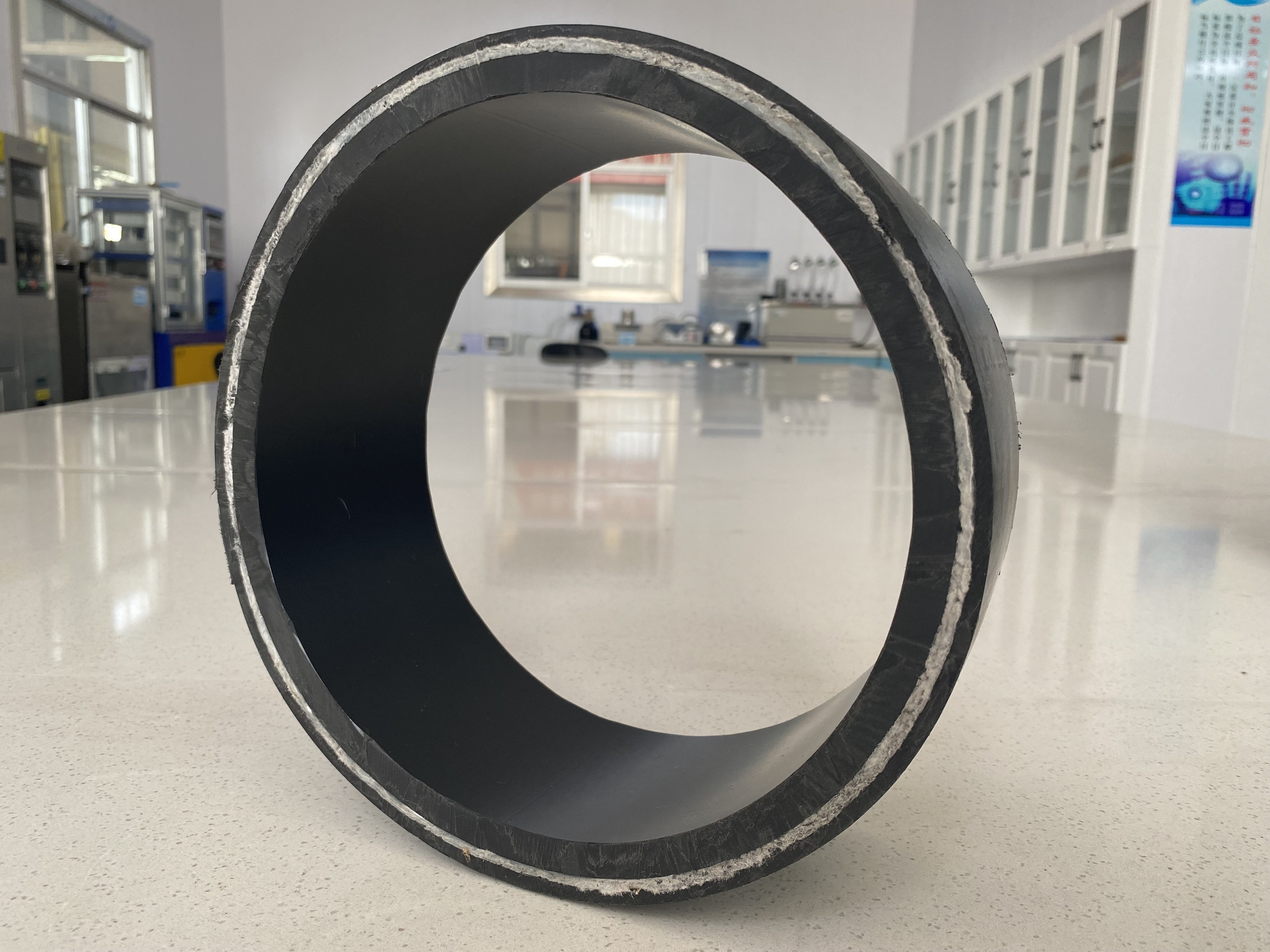 Reinforced ultra-high polymer continuous composite pipe